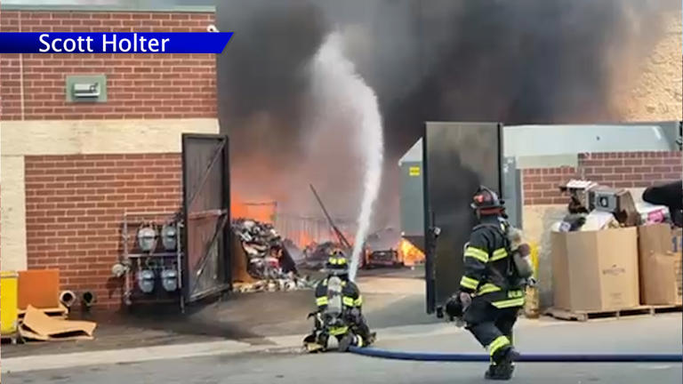 Black smoke, flames seen as fire breaks out behind Littleton thrift store