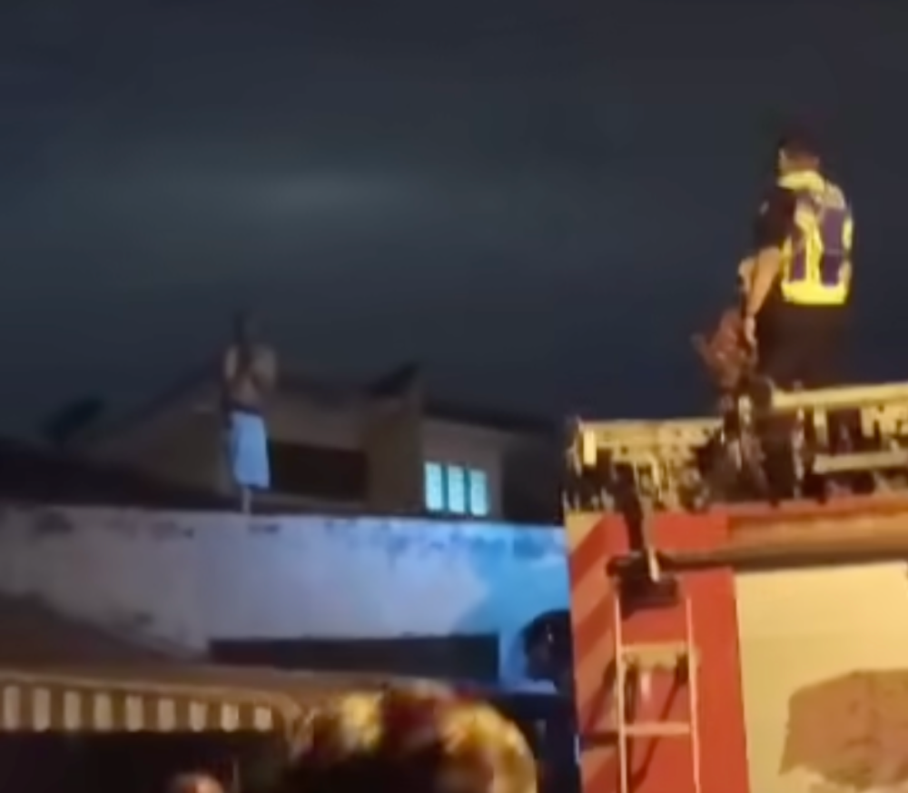 Partially clothed man with knife detained after four-hour rooftop ...