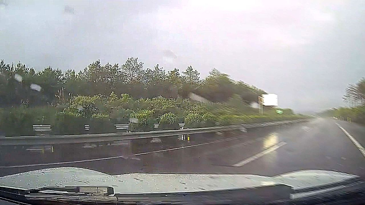 Driver regains control after car skids in heavy rain
