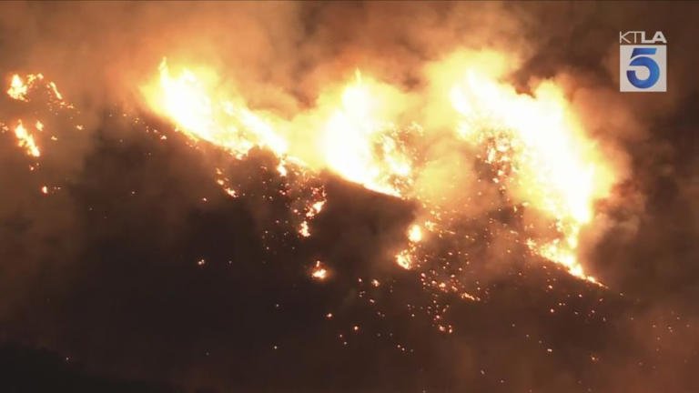 Evacuation orders issued as fast-moving wildfire burns in Riverside County