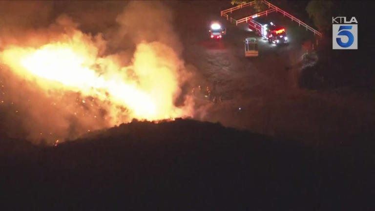 Evacuation orders issued as fast-moving wildfire burns in Riverside County