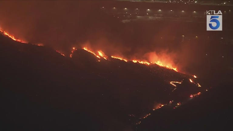 Evacuation orders issued as fast-moving wildfire burns in Riverside County