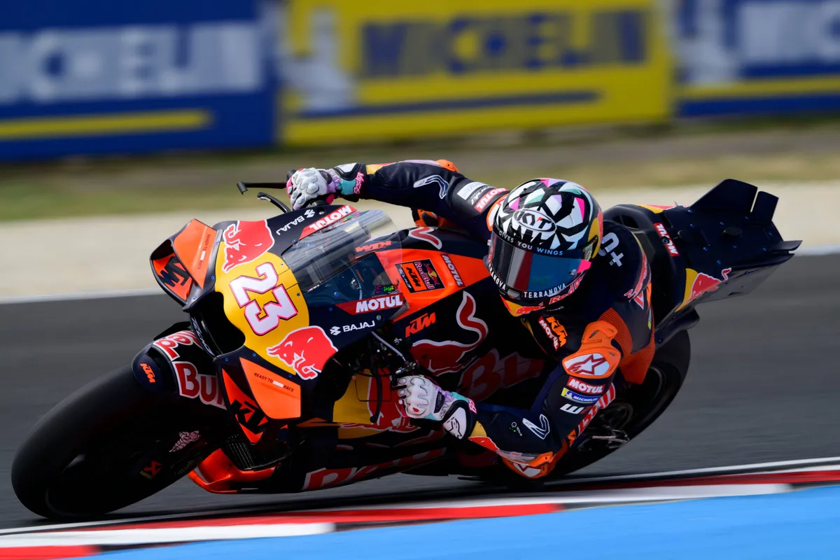 MotoGP rider slides back onto track after crash and is nearly run over