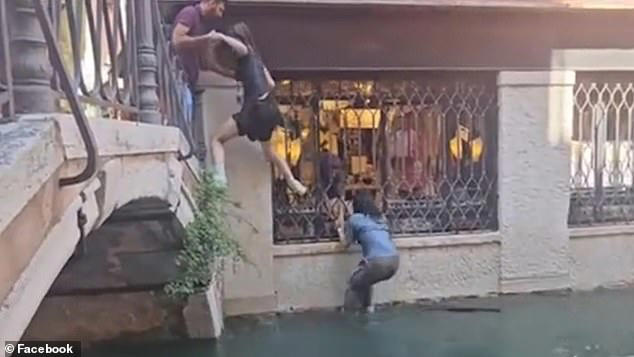 Moment tourists are dragged out of a canal after tipping over their ...