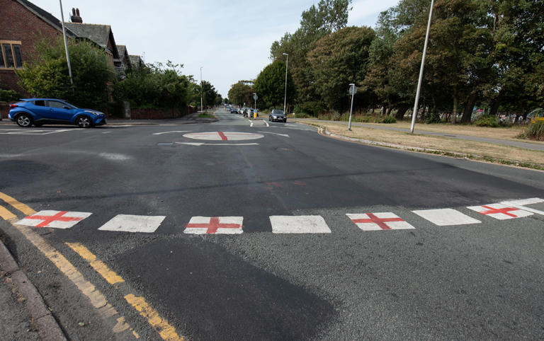 St George's Cross painted on mini-roundabout and road markings in ...