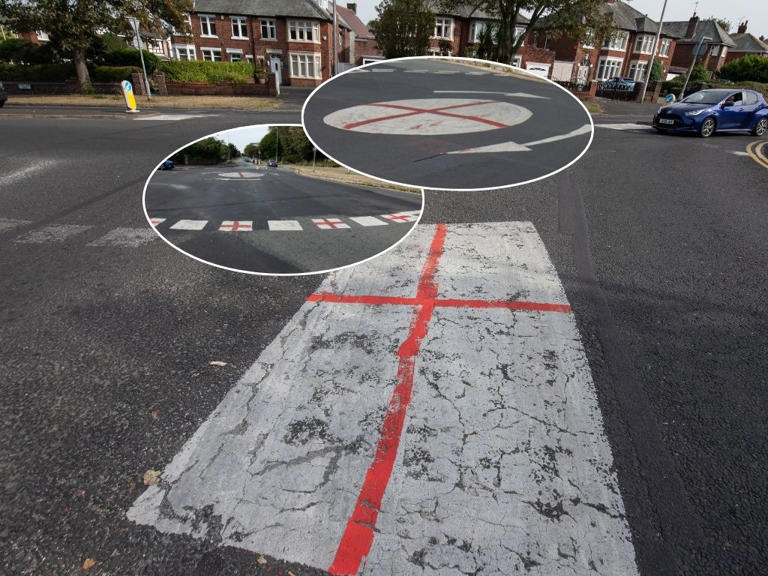 St George's Cross painted on mini-roundabout and road markings in ...