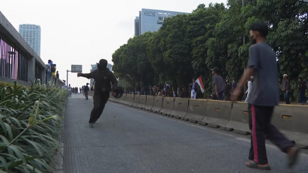 Indonesian police fire tear gas as thousands of protesters try to reach ...