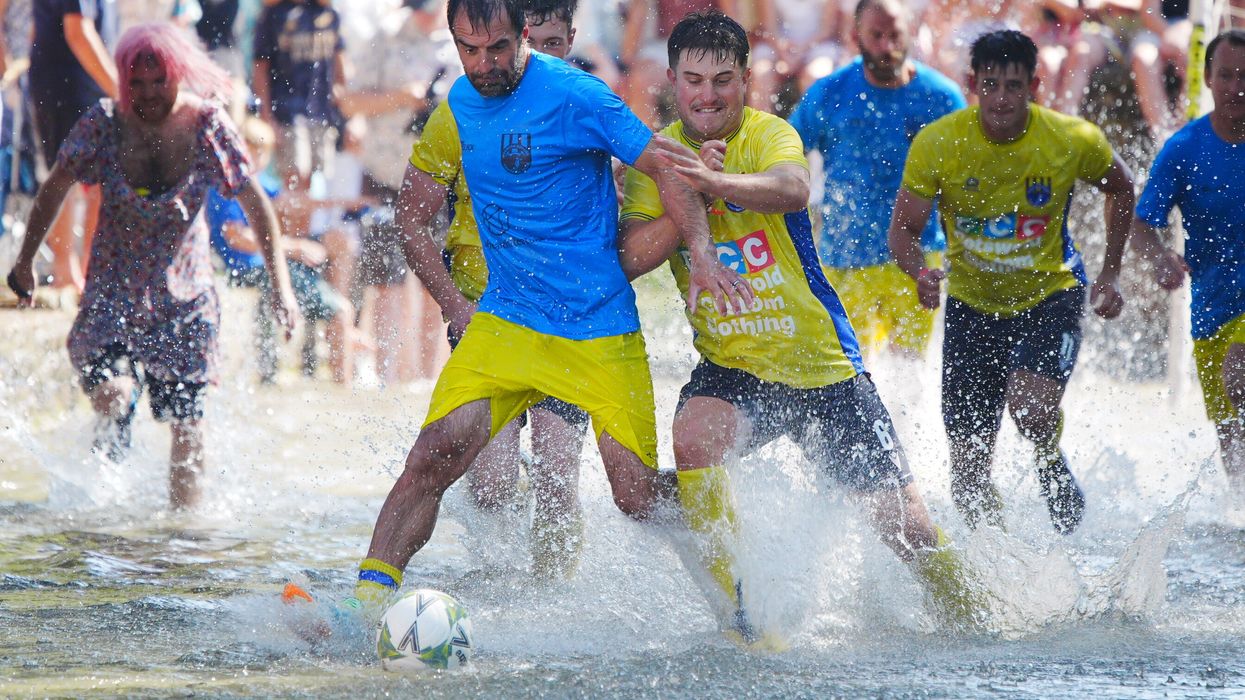 Annual river football clash goes ahead despite waterlogged pitch