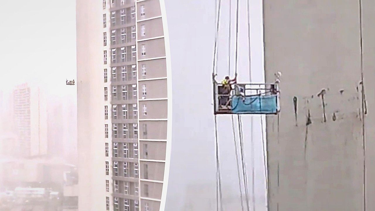 High-rise window cleaners trapped on swinging platform as storm hits