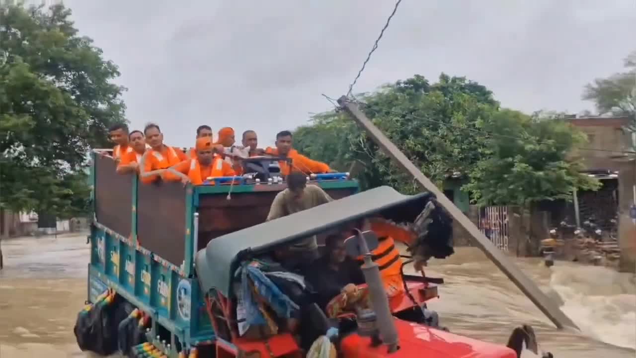 Tractor trailer rescuing residents from flood overturns dumping them in ...