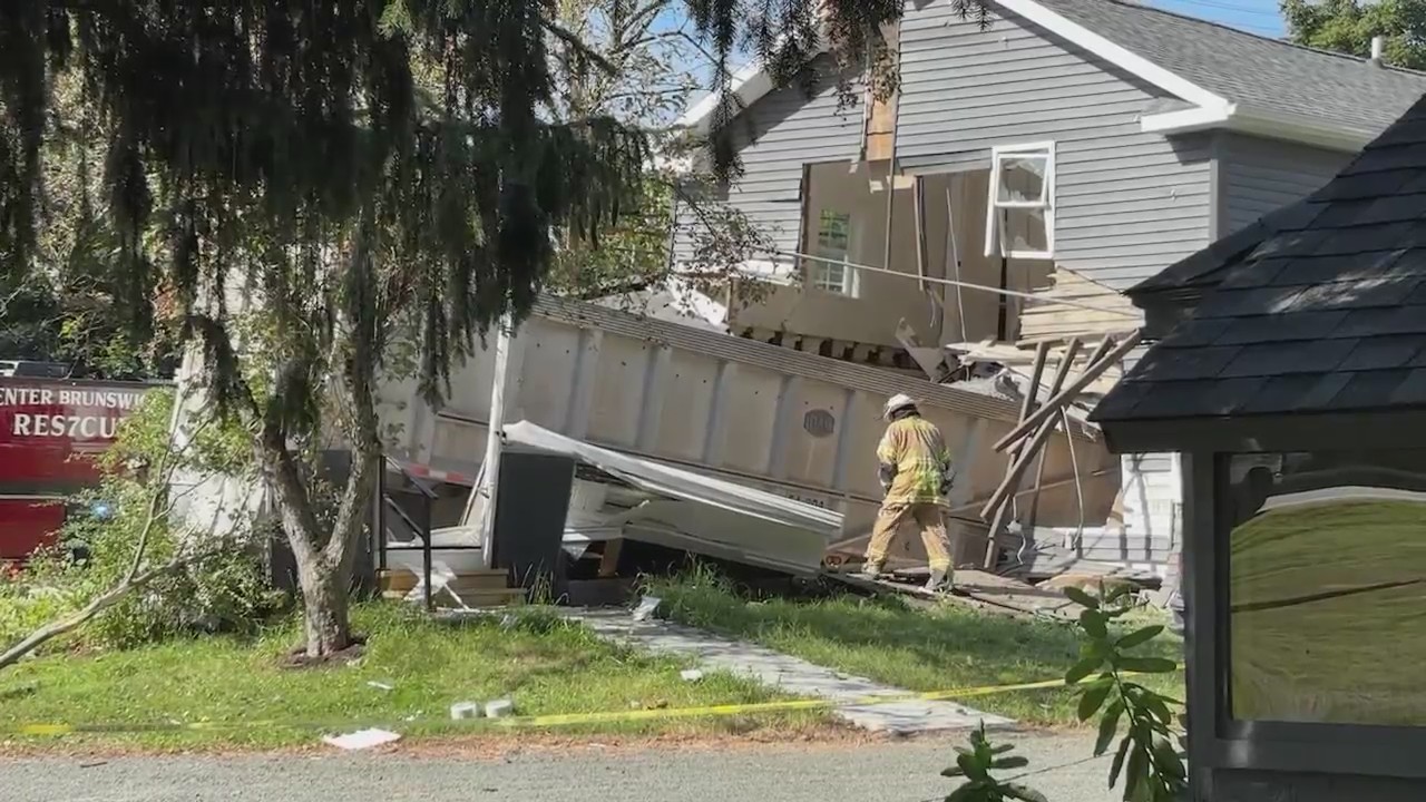 Driver dies after truck crashes into home in Brunswick