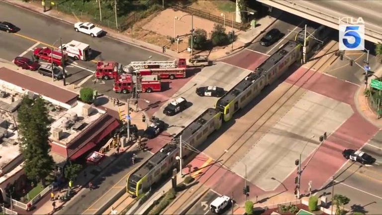 Driver hospitalized after car collides with train, crashes into East L ...