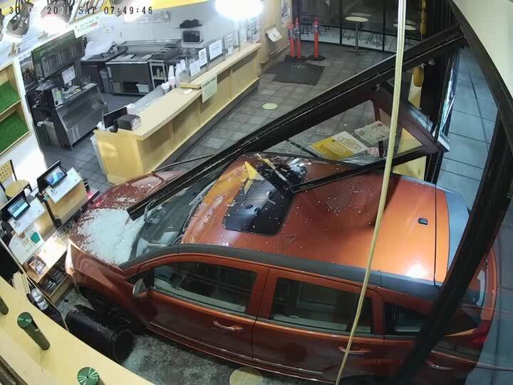 Person Drives New Car Into Food Store's Glass Door And Shatters It