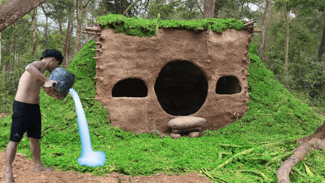 Building primitive mud houses with grass growing around