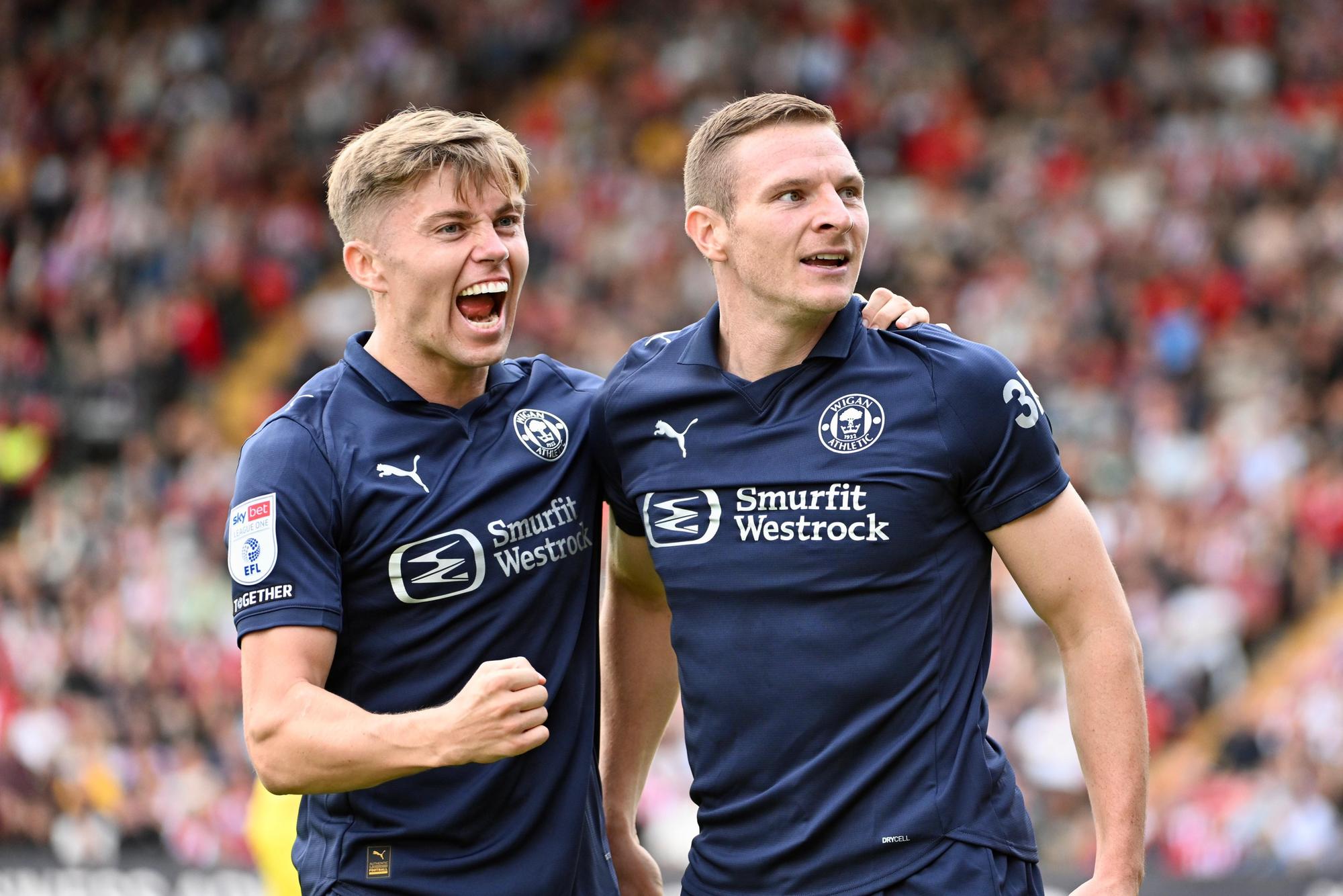 Wigan Athletic and Lincoln City share four goals and two red cards in ...