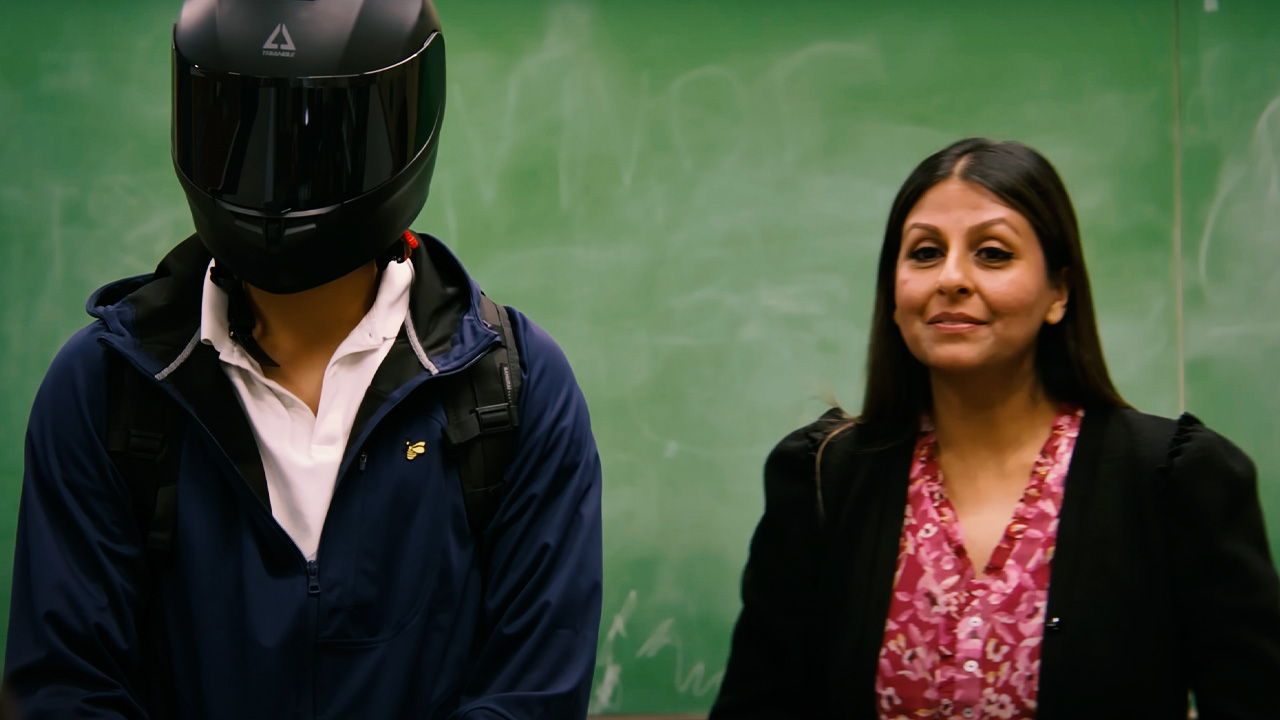 Handsome boy wears helmet to avoid girls?