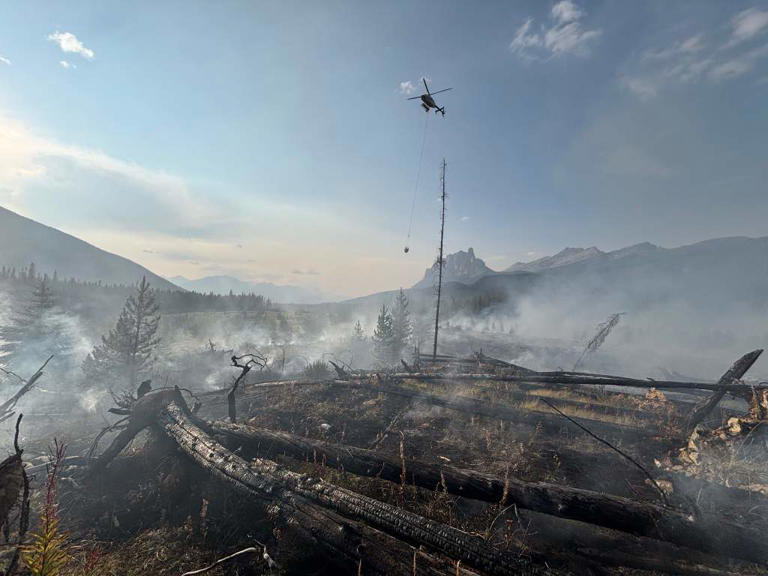 Fire crews working to extinguish a wildfire just west of Banff townsite