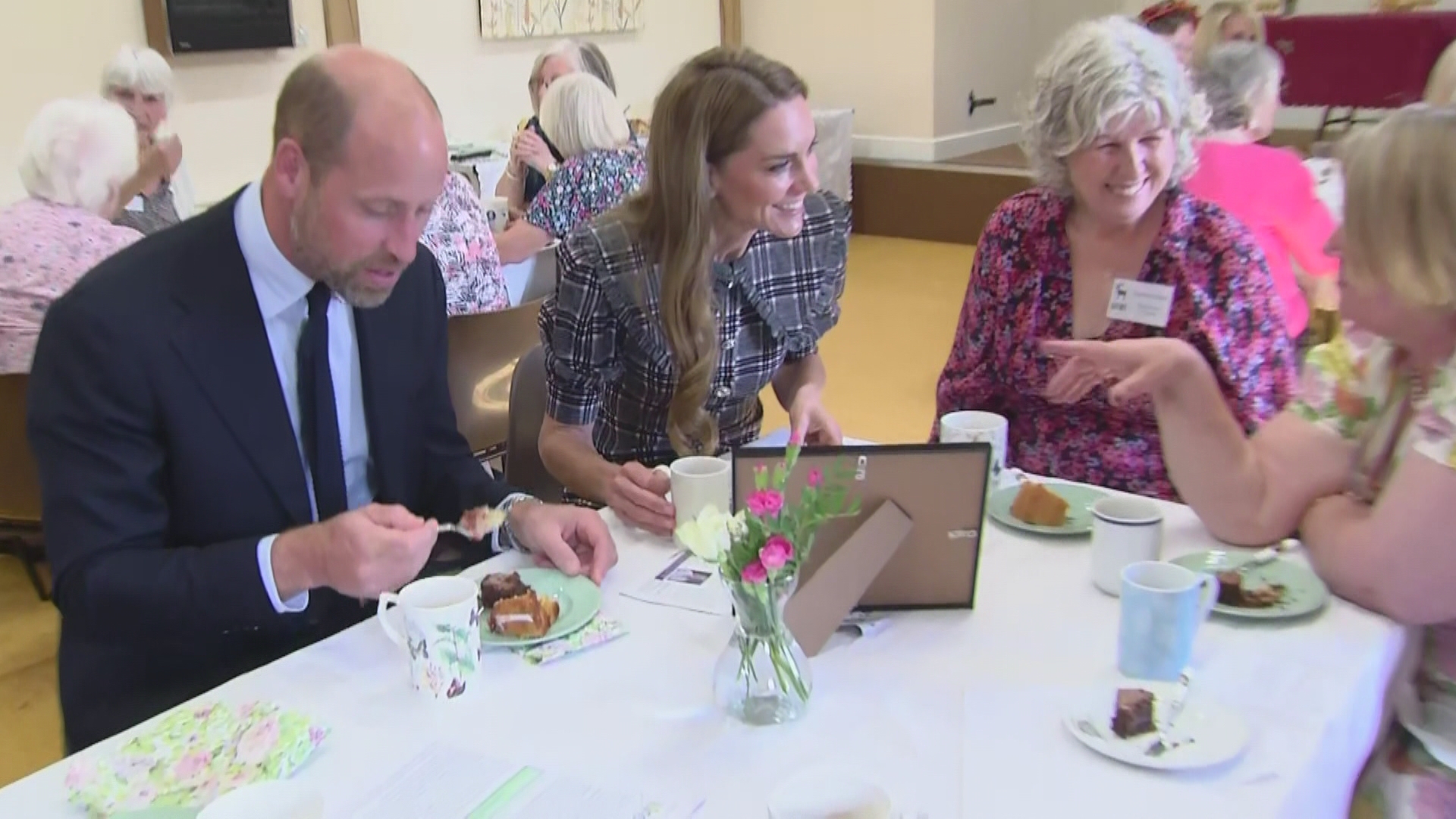 Prince William enjoys cake during Queen anniversary visit