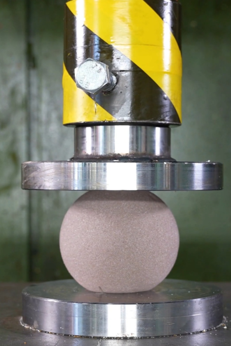 Kamienna kula pod prasą hydrauliczną