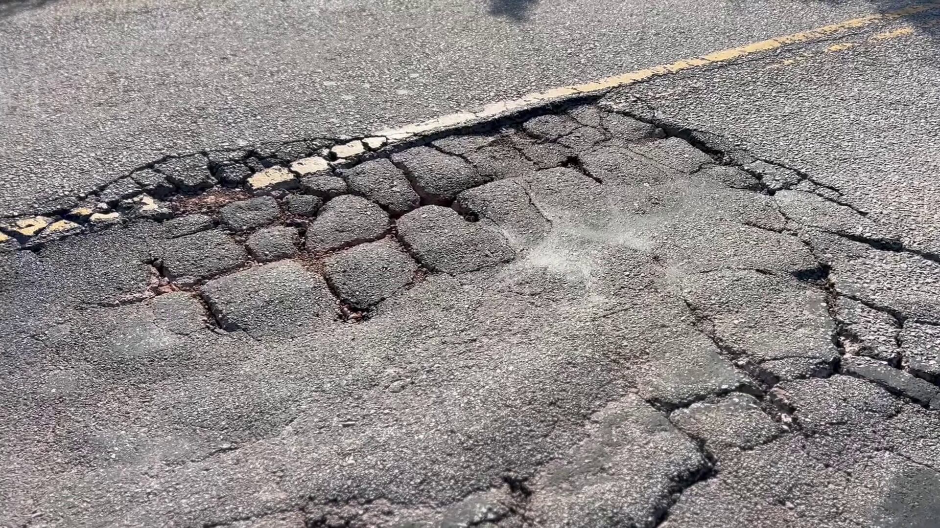Potholes, cracks, blind spots on road near I-26 leave neighbors frustrated