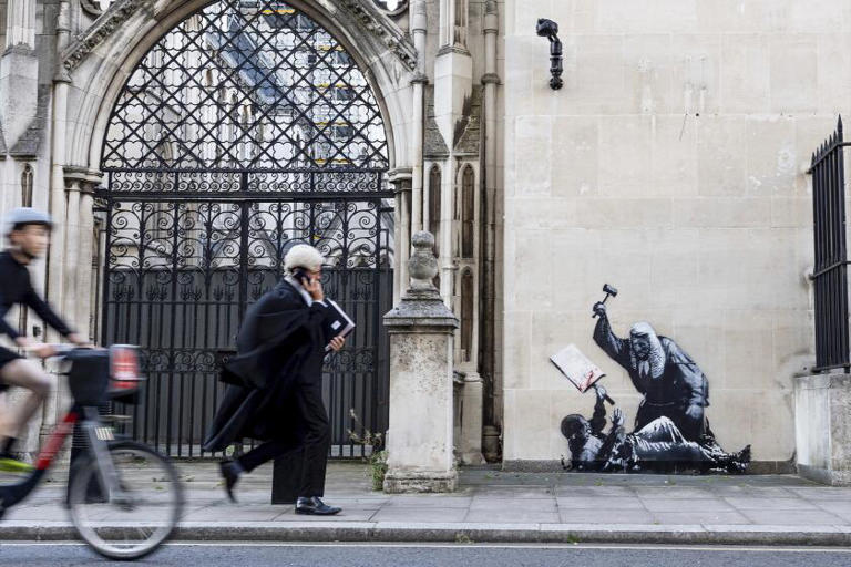 Banksy unveils a new mural of a judge beating a protester outside ...
