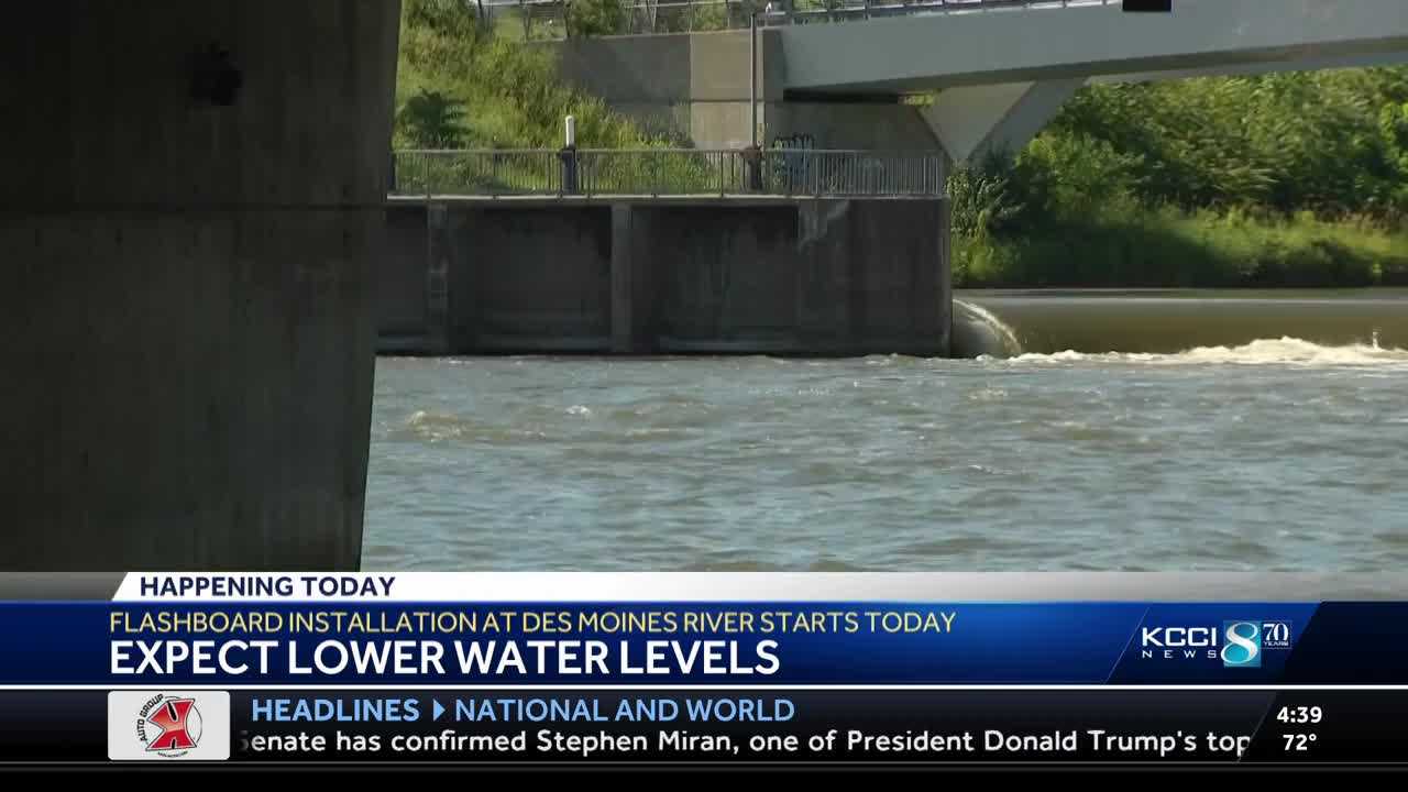 Workers installing flashboards on Center Street Dam in downtown Des Moines