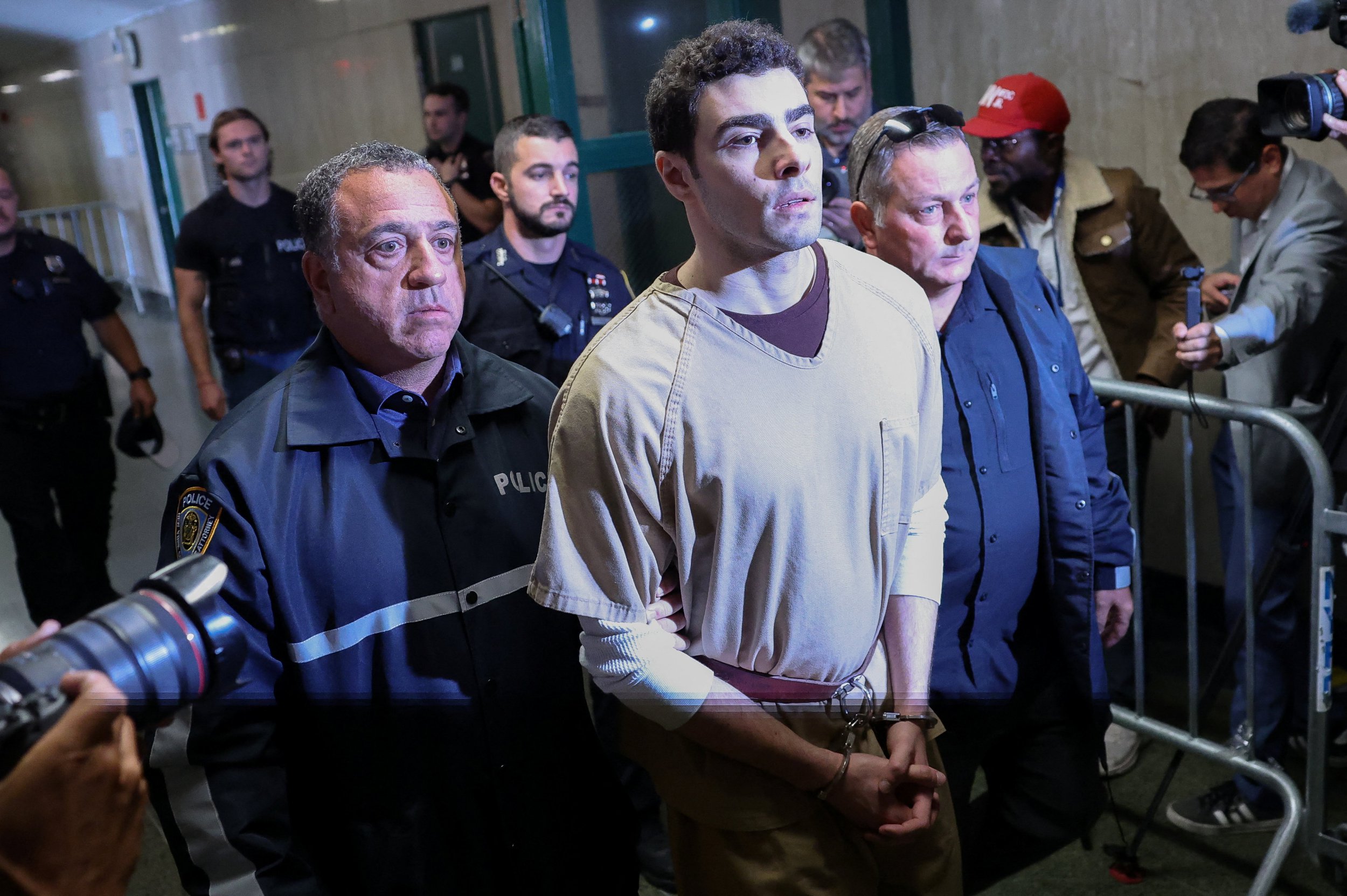 Cheers as court drops two charges against Mangione