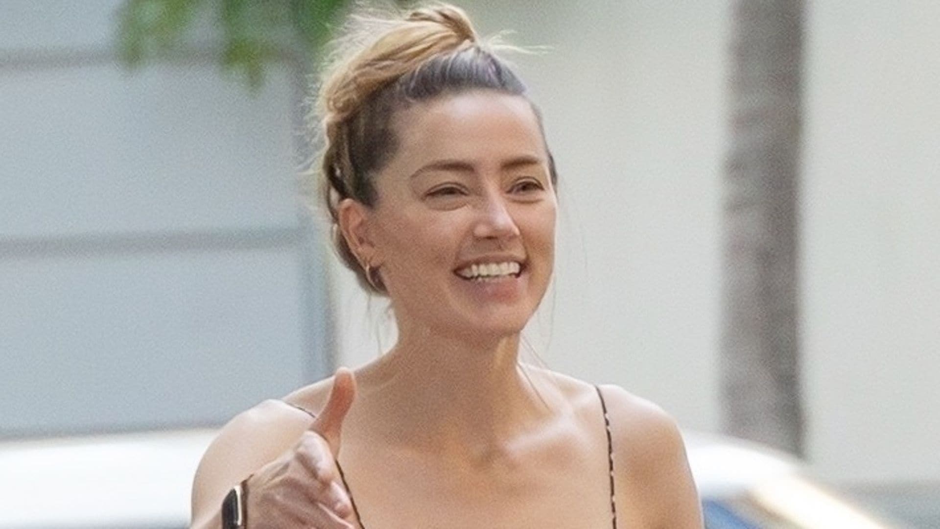 Amber Heard laughs and embraces life in Madrid after US trip