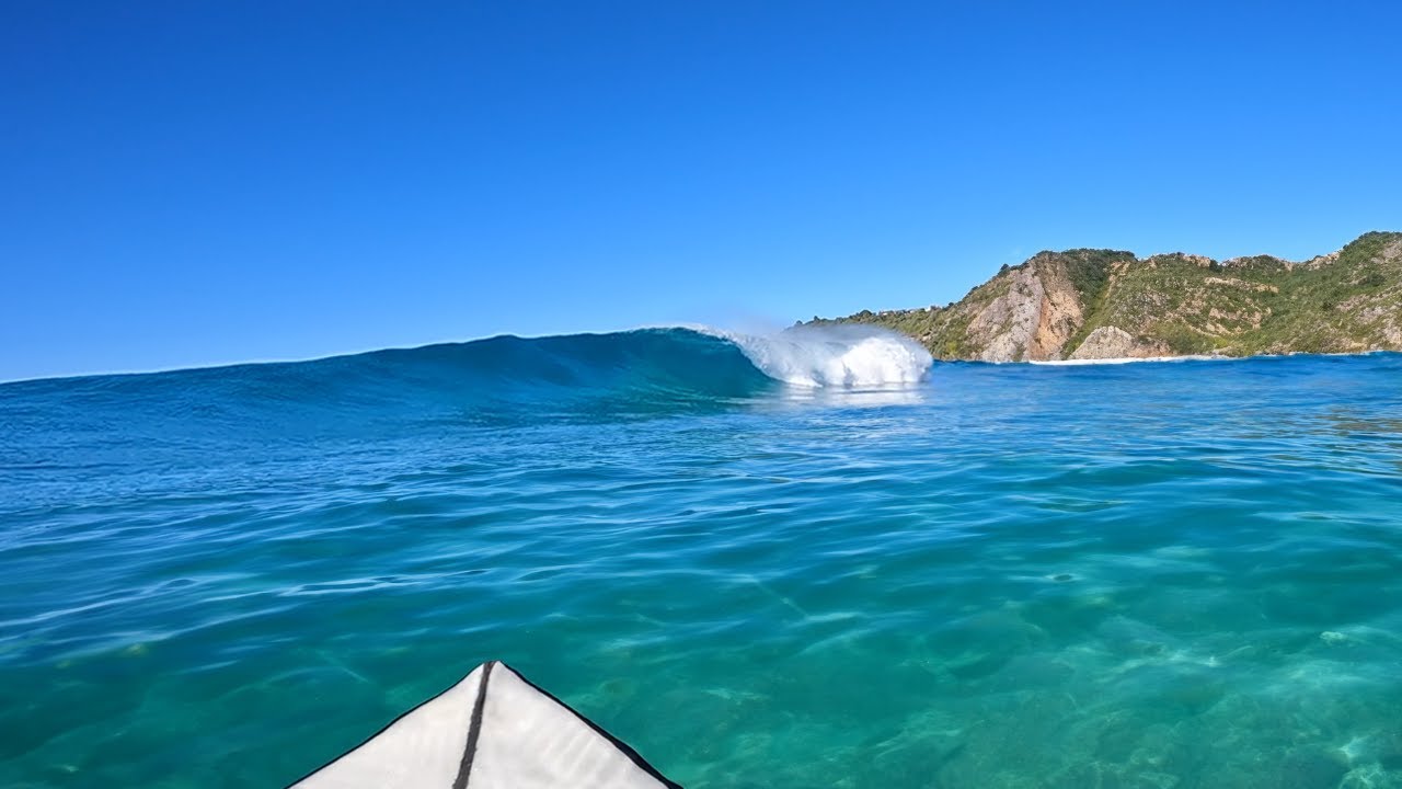Surfing a crystal clear beach break
