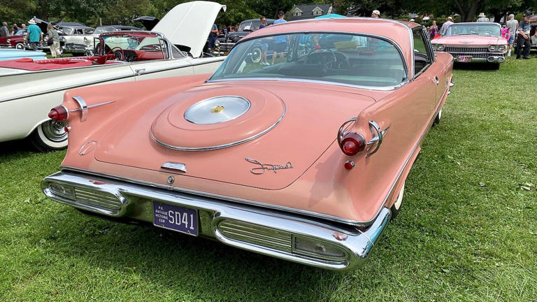 Why did old cars have gas caps hidden behind license plates?