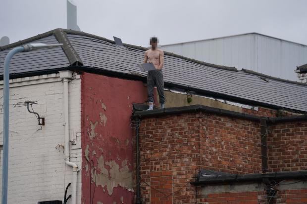 Shirtless 'tile thrower' arrested after police called to rooftop drama