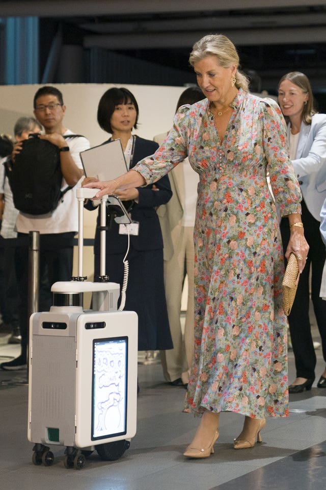 Duchess of Edinburgh interacts with robot dog during Japan visit