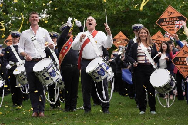 Dorset MP joins Lib Dem leader at head of marching band