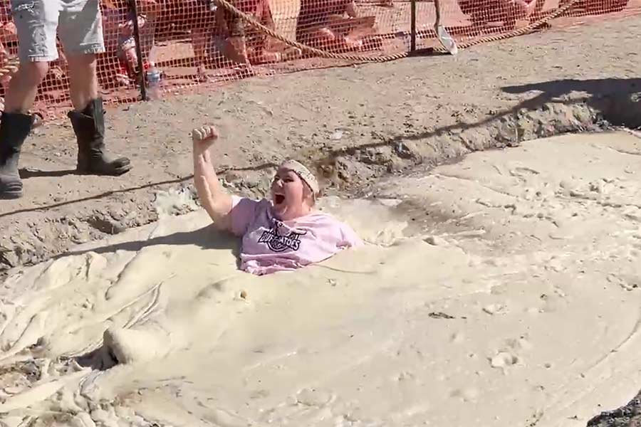 Contestants try to avoid falling into pit filled with 1,000 gallons of ...