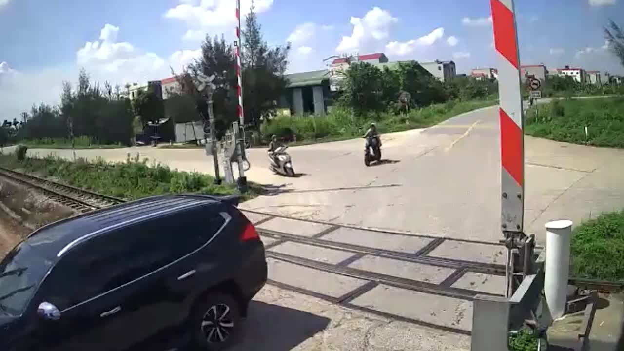 Truck crashes into train barrier on level crossing in Vietnam