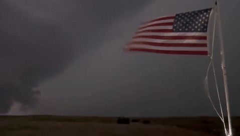 American Flag Flutters in Extreme Winds as Funnel Cloud Forms in Distance