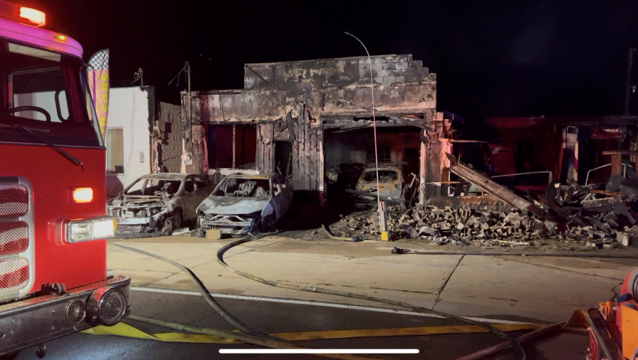Fire crews work to put out heavy fire at used car dealership on 11th Street