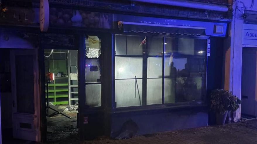 Residents flee flats after shop below catches fire