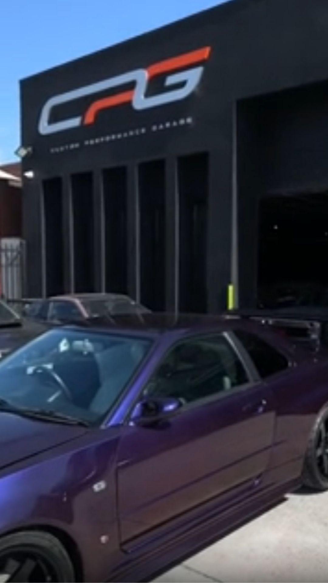 Midnight Purple R34 GTR sitting pretty out the front of CPG in Melbourne