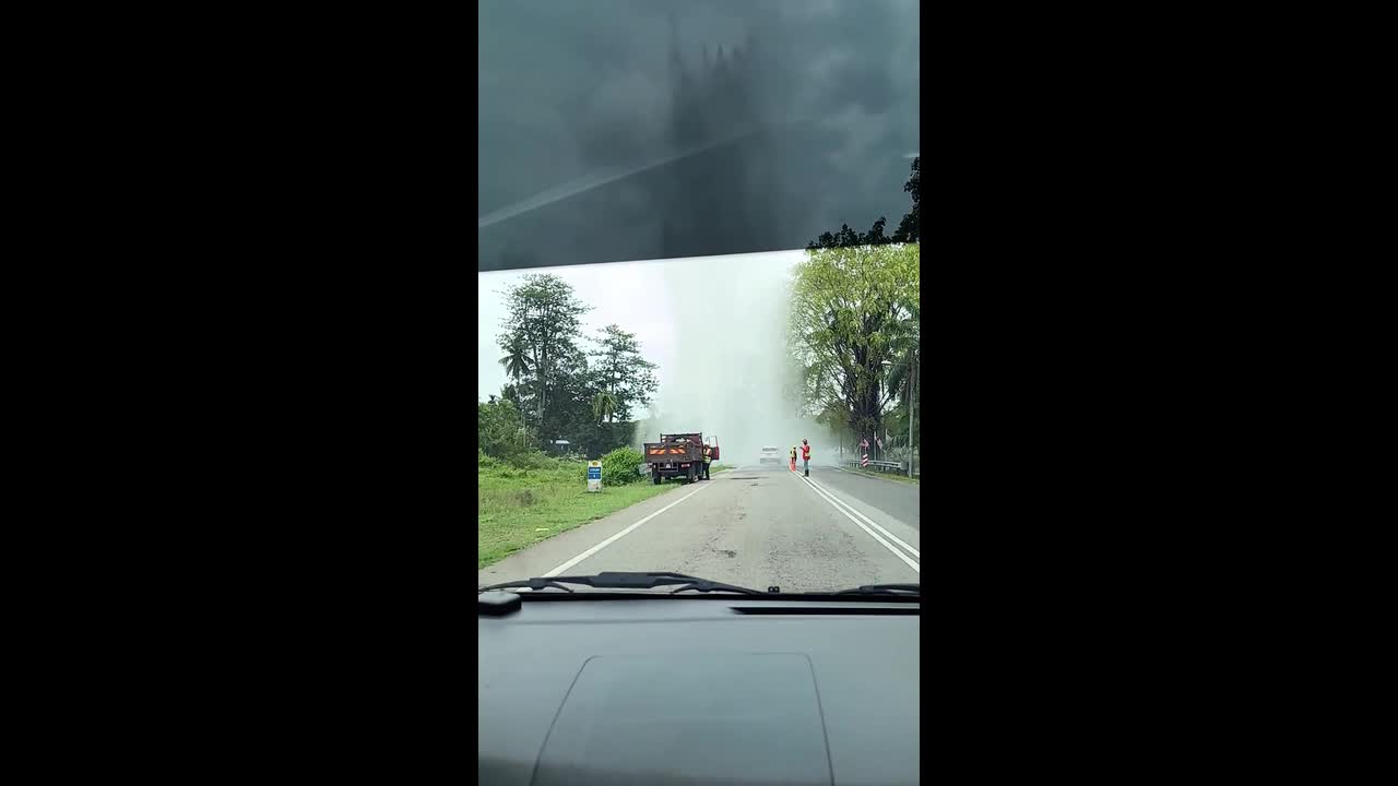 Passing vehicles gets free car wash from burst pipeline
