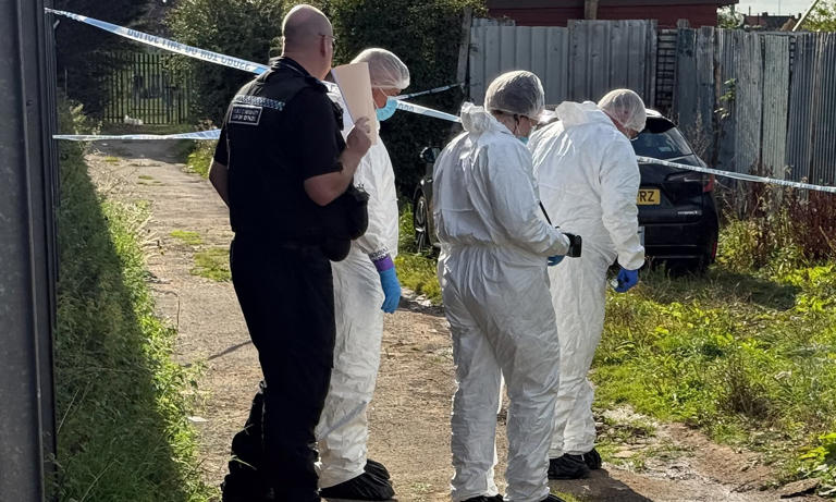 Dead body is found in allotment as forensics in hazmat suits comb scene ...