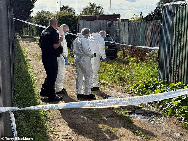 Dead body is found in allotment as forensics in hazmat suits comb scene ...