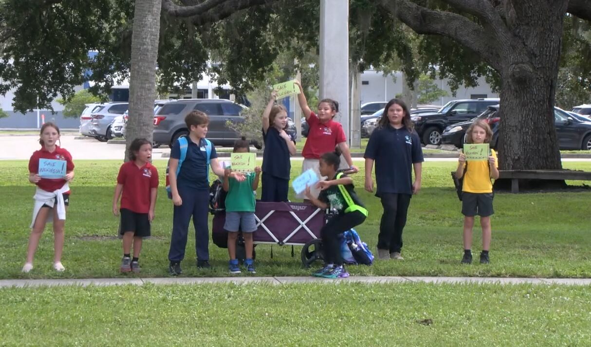 Parents and children rally outside of Wilkinson Elementary as the ...