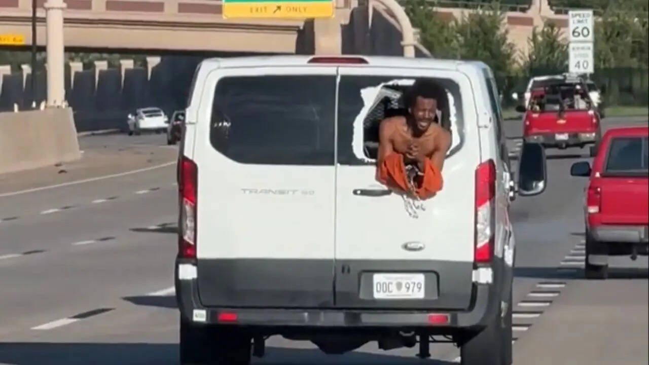 Handcuffed Prisoner Spotted Dangling Out Of Prison Van Window On US ...