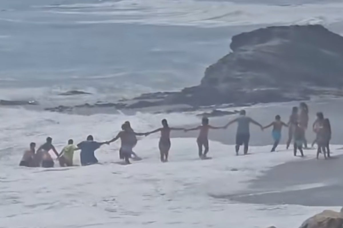 Beachgoers form human chain to save boy from being swept out to sea