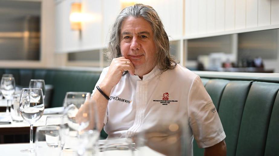 Michael Deane apologises after migrant delivery driver post