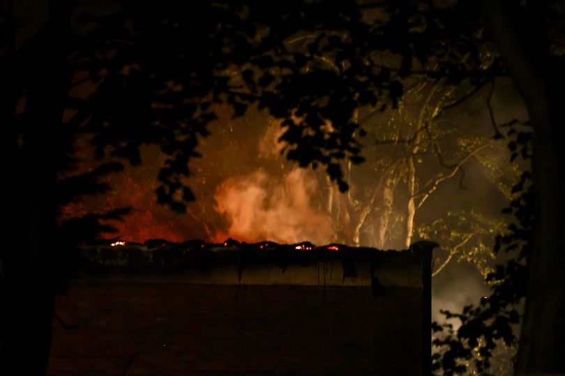 Firefighters remain at the scene after fire at former school