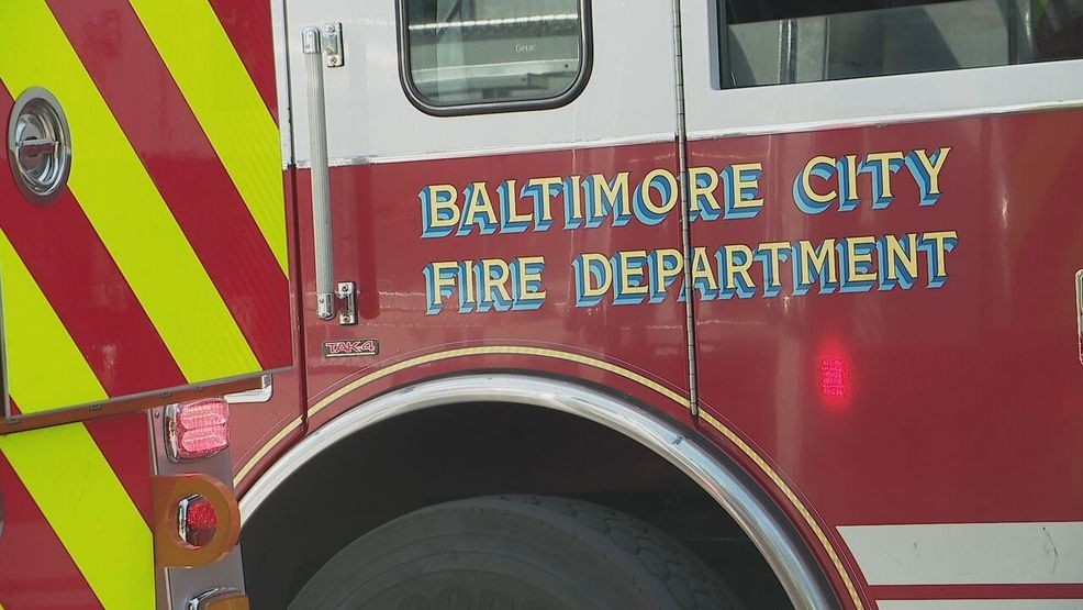 One hospitalized after vehicle catches fire, strikes building in Baltimore