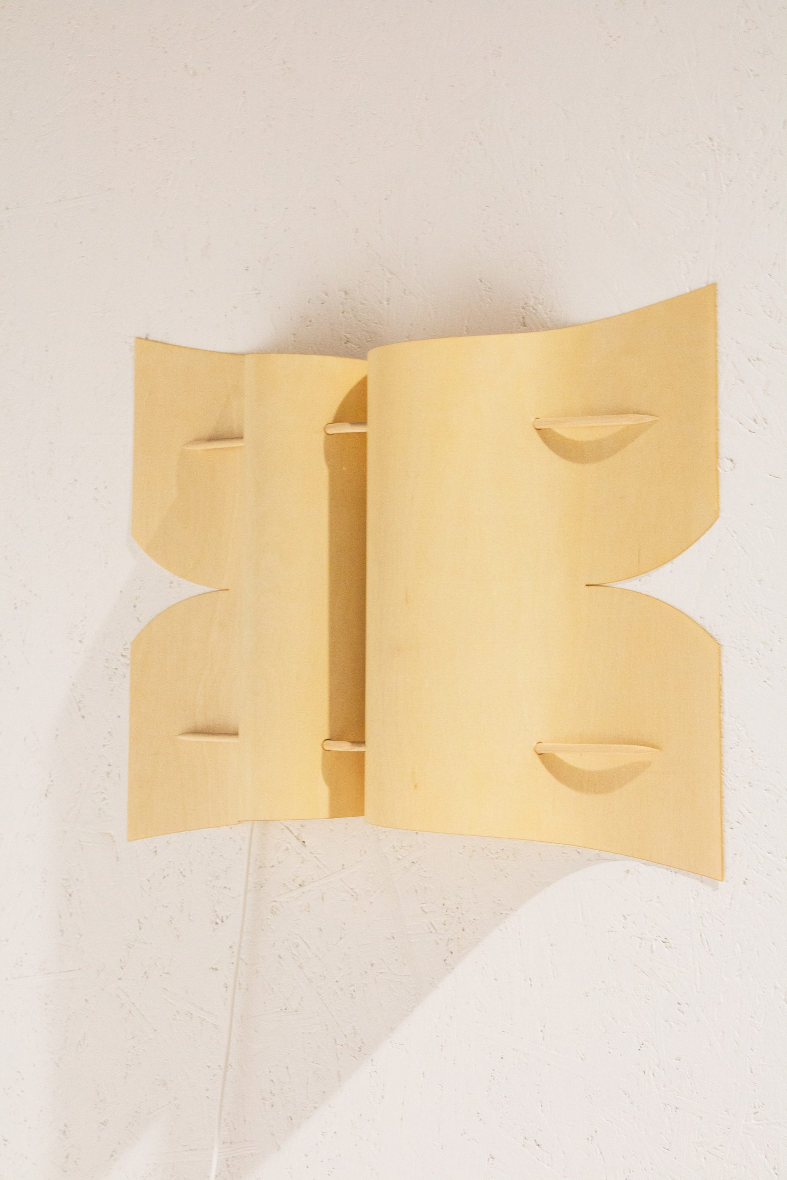 Folded timber lamp by Anton Mikkonen resembles "a butterfly pinned to the wall"