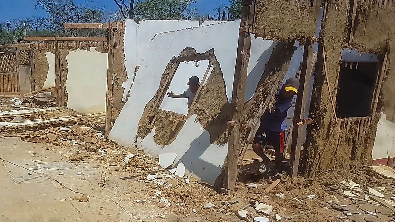 Construction workers dodge falling wall